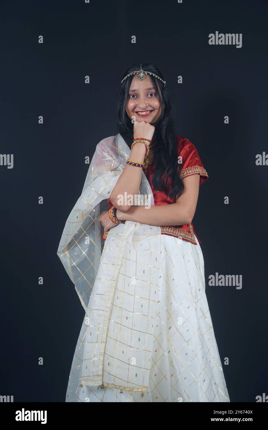 This vibrant stock image captures an Indian young girl dressed in ...