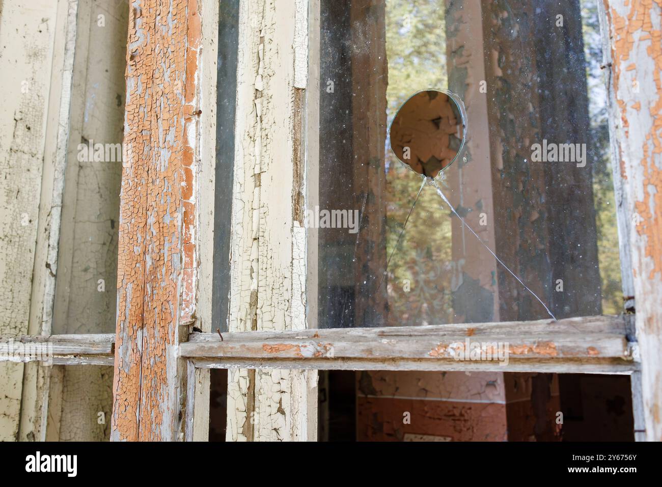 Broken glass in the window of an old house. Close-up. Old wooden window ...