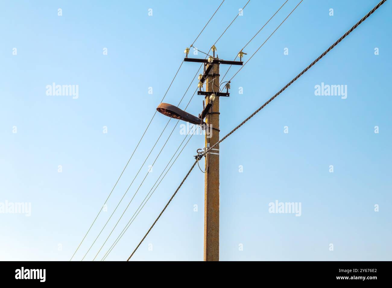 Power lines on the background of the blue sky close-up. Electric hub on ...