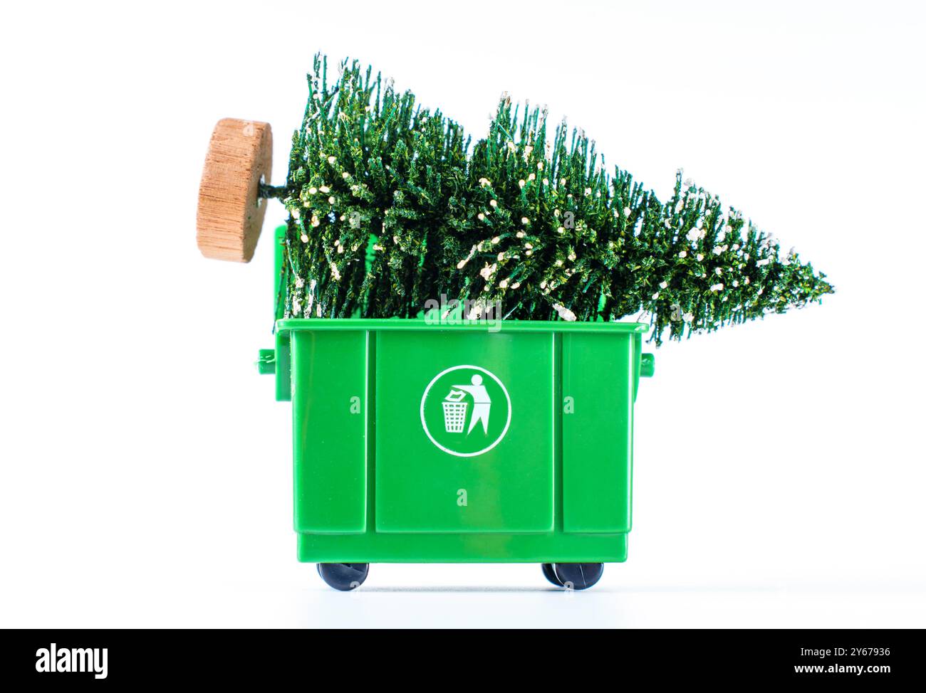 Small artificial Christmas tree with a wooden base sitting inside a ...