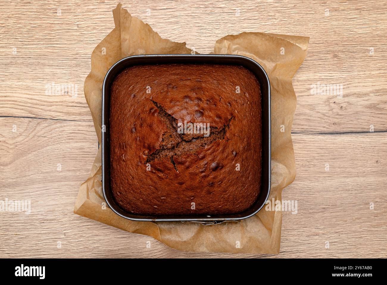 Baked cocoa cake lying on a square baking tray Stock Photo - Alamy