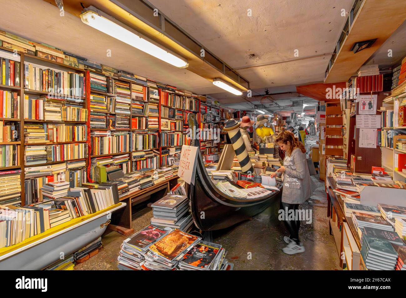 People browsing books inside Libreria Acqua Alta a quirky,popular book ...