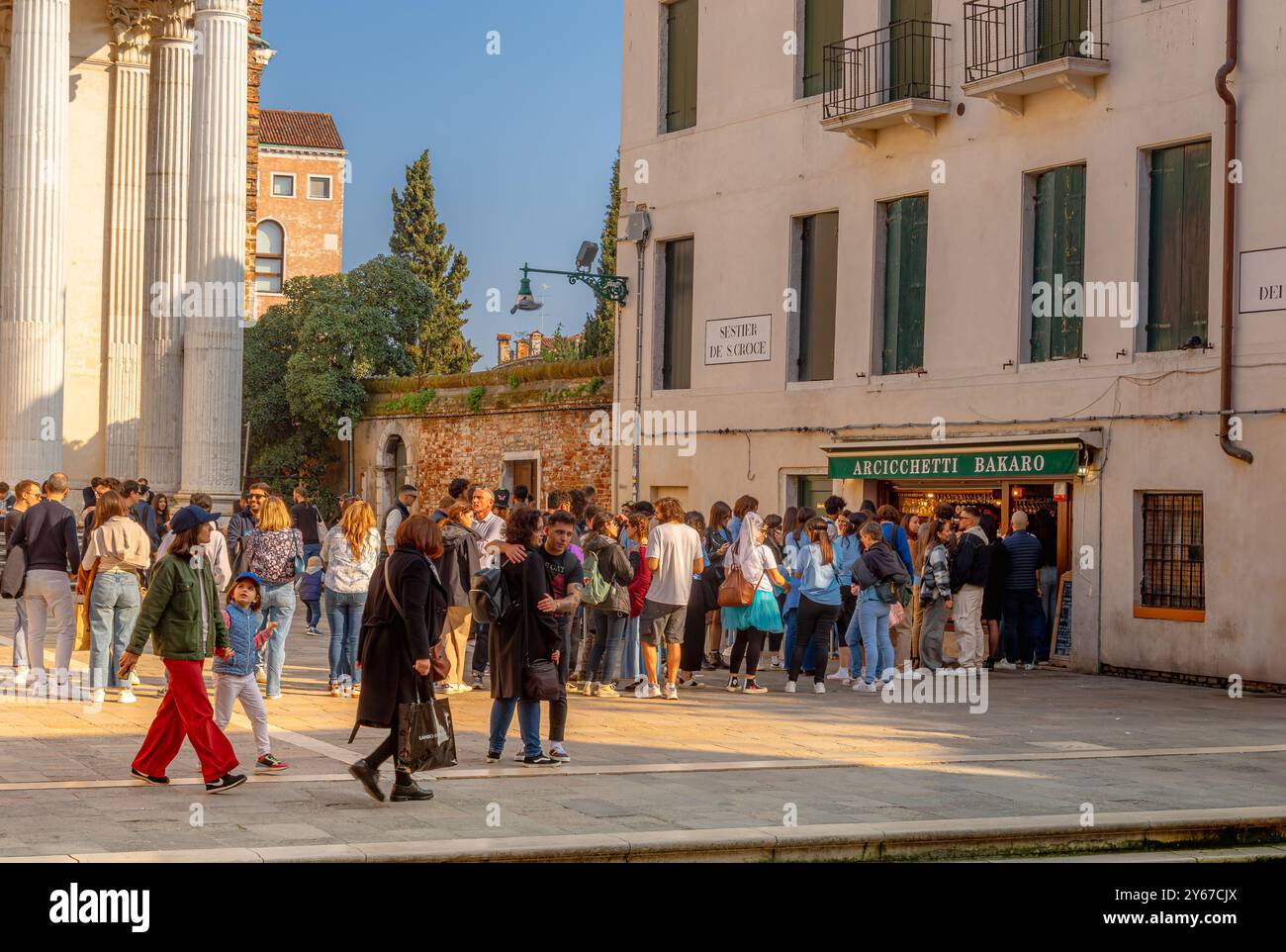 A line of people queuing outside Arcicchetto Bakaro a popular wine bar ...