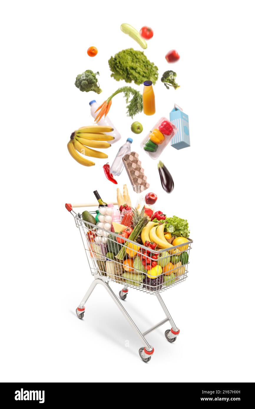 Different food products falling into a shopping cart isolated on white ...