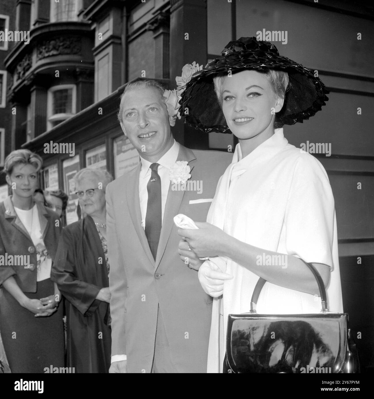 Fashion model Margaret Simons wearing wide brimmed black straw hat ...