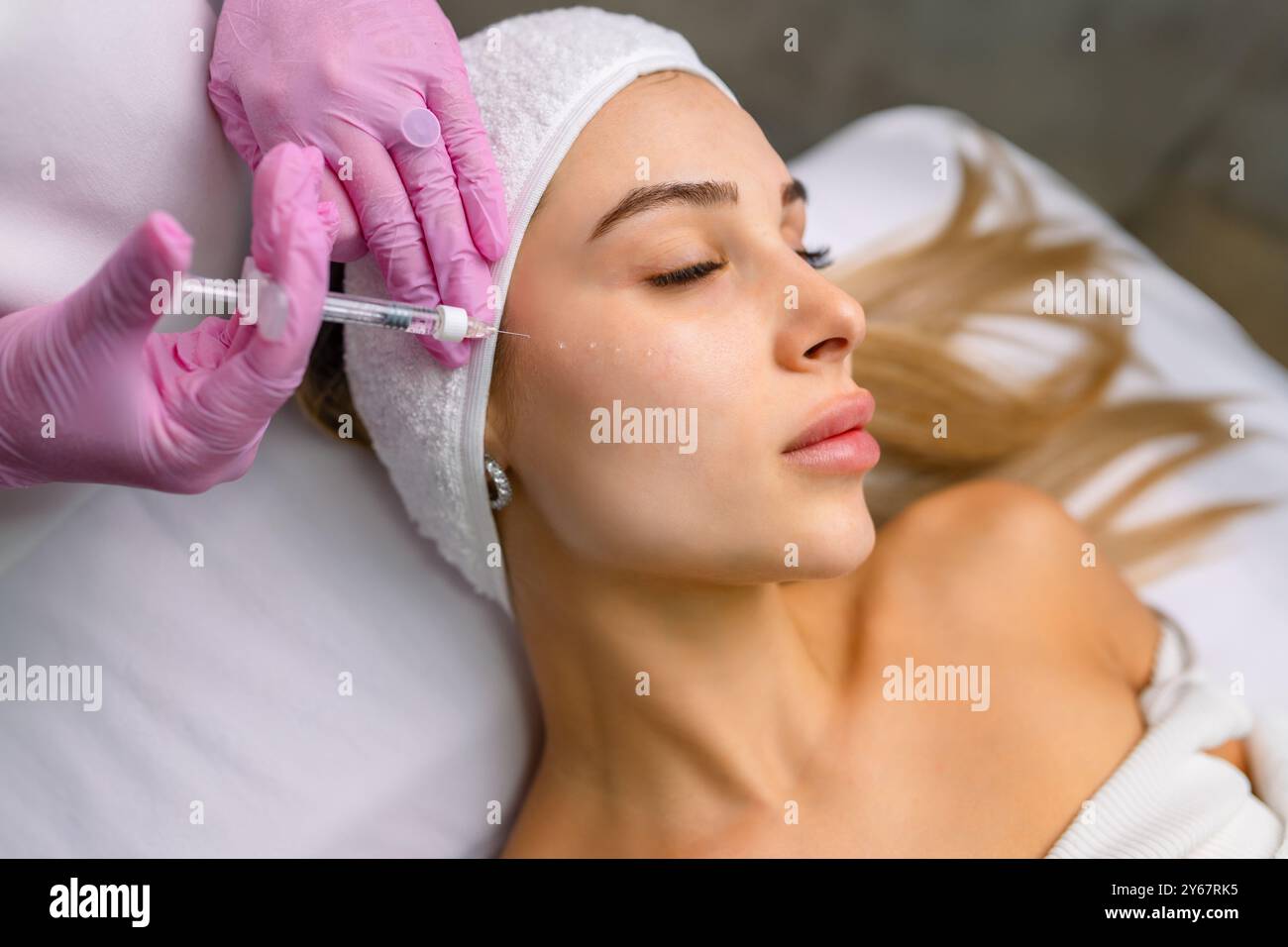 Beautiful relaxed woman at beautician cabinet receiving anti wrinkle ...