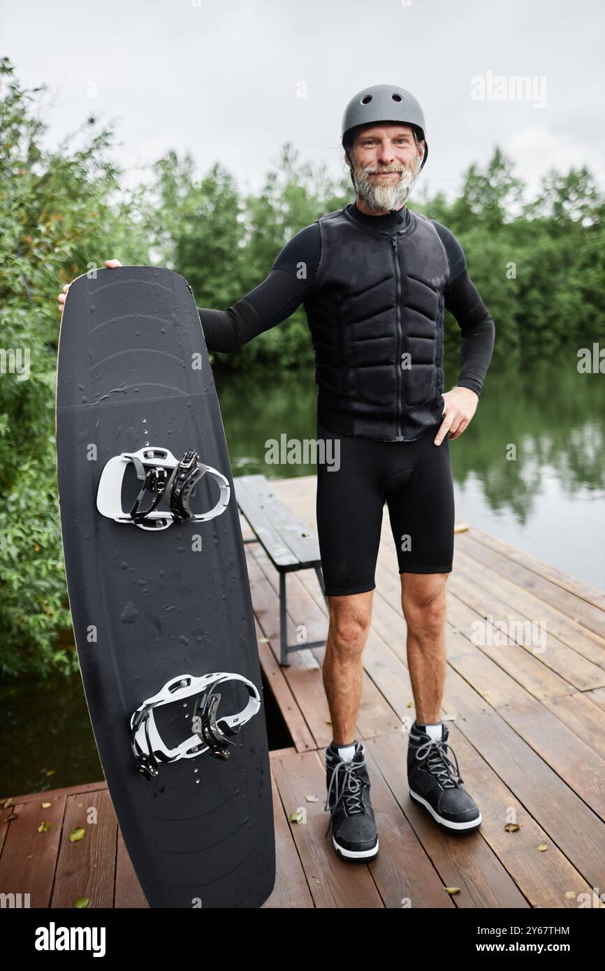 Vertical full length portrait of bearded senior man wearing ...