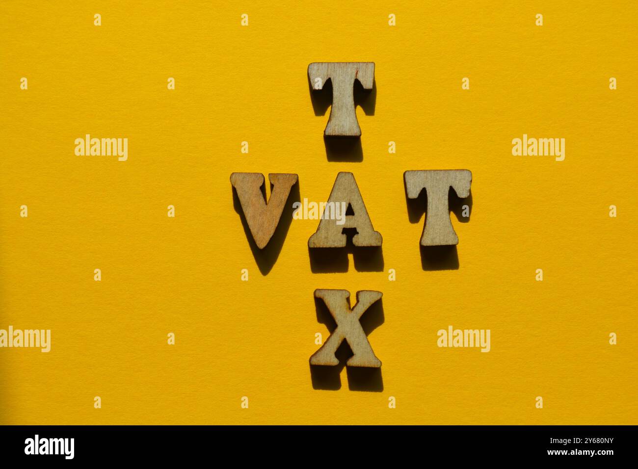 VAT and Tax, acronym and word in wooden alphabet letters in crossword ...