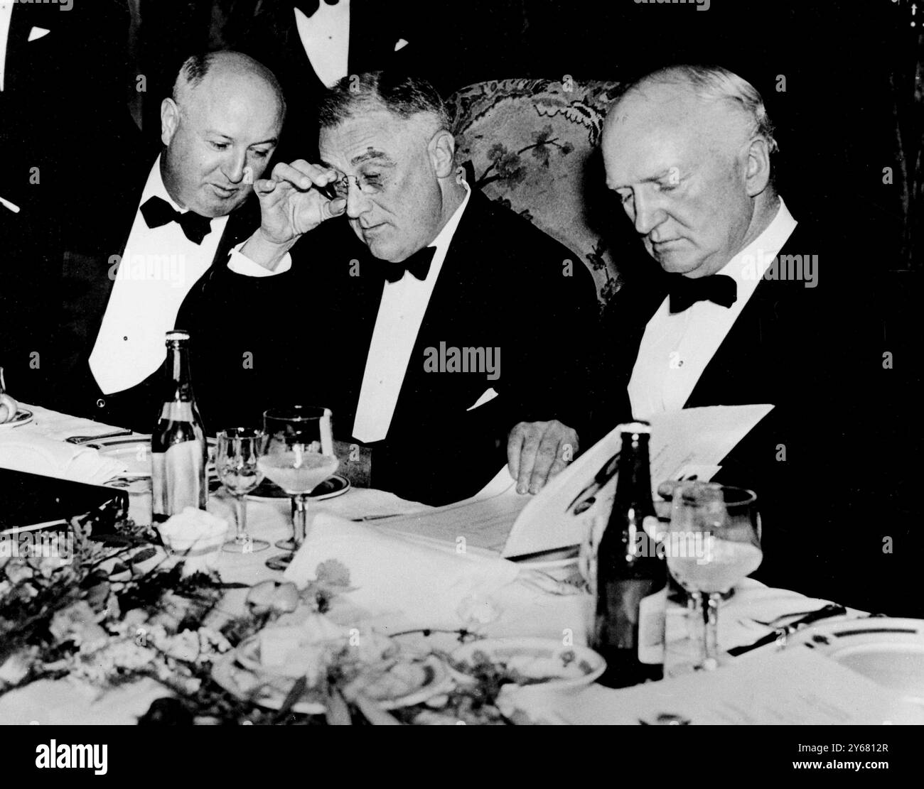 President Franklin D Roosevelt peering through his glasses at the menu ...