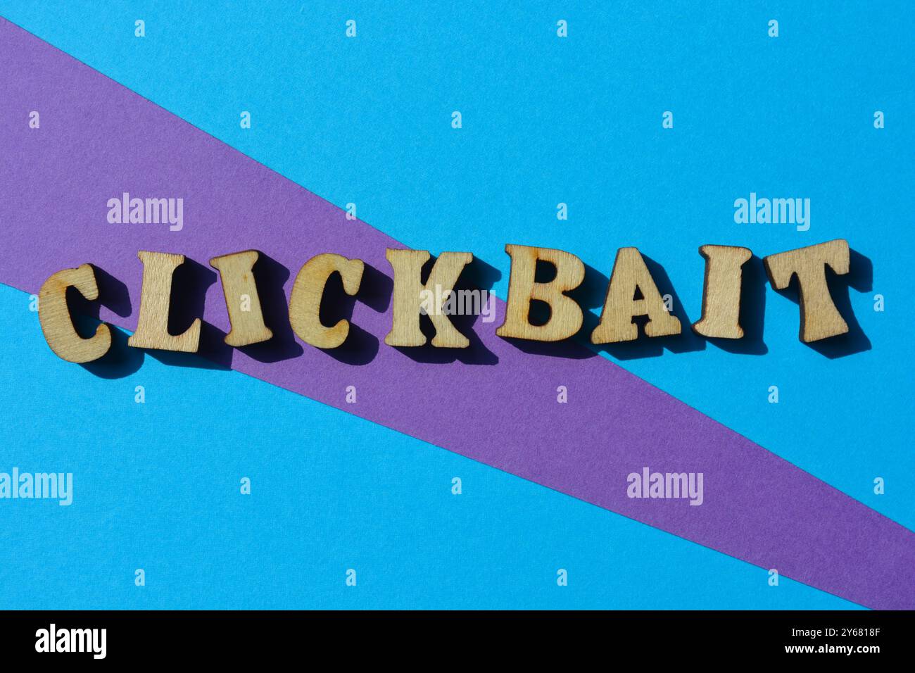 Clickbait, word in wooden alphabet letters isolated on colourful ...