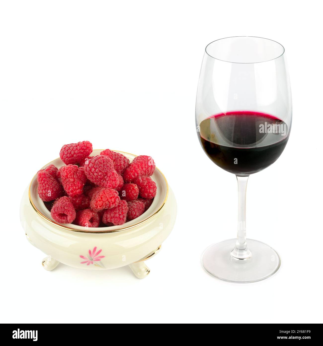 Raspberries in a vintage porcelain bowl and raspberry juice in a glass ...