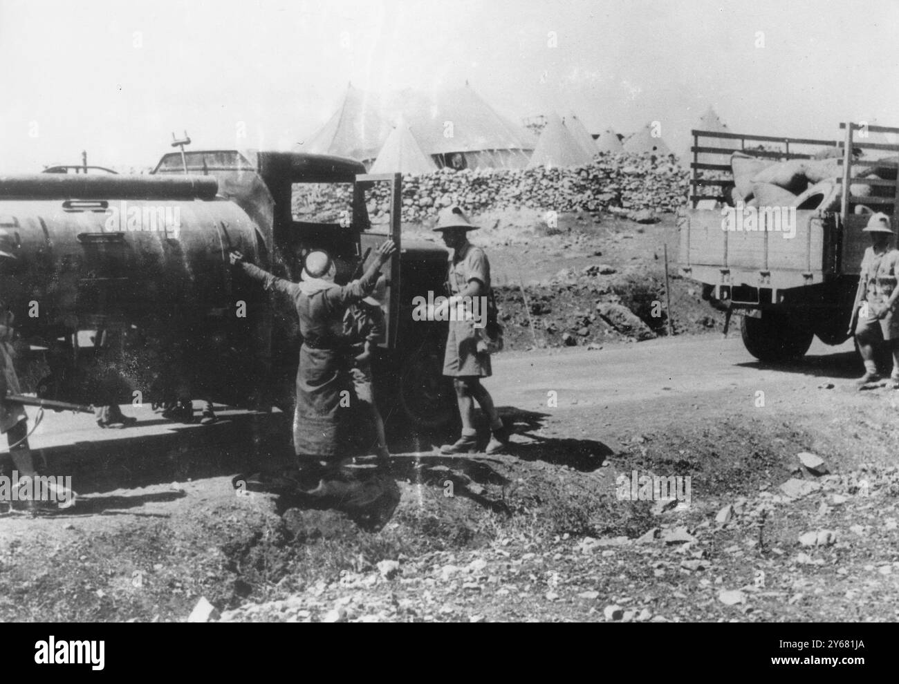 A British soldier searching an Arab suspect for arms on the road to ...