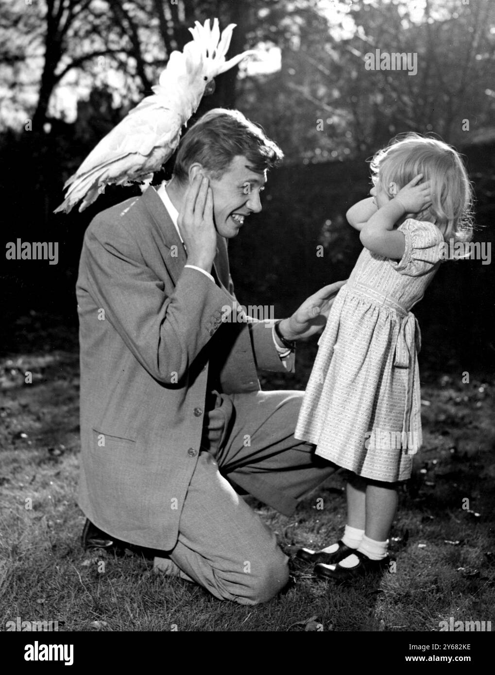 3 year old Susan and her father David Attenborough cover their ears as ...