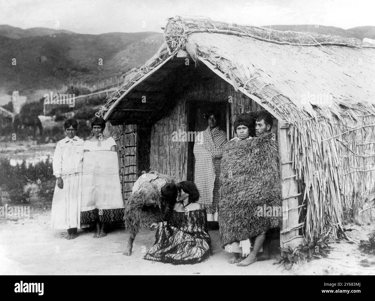 New Zealand native maori home with a couple in traditional greeting of ...
