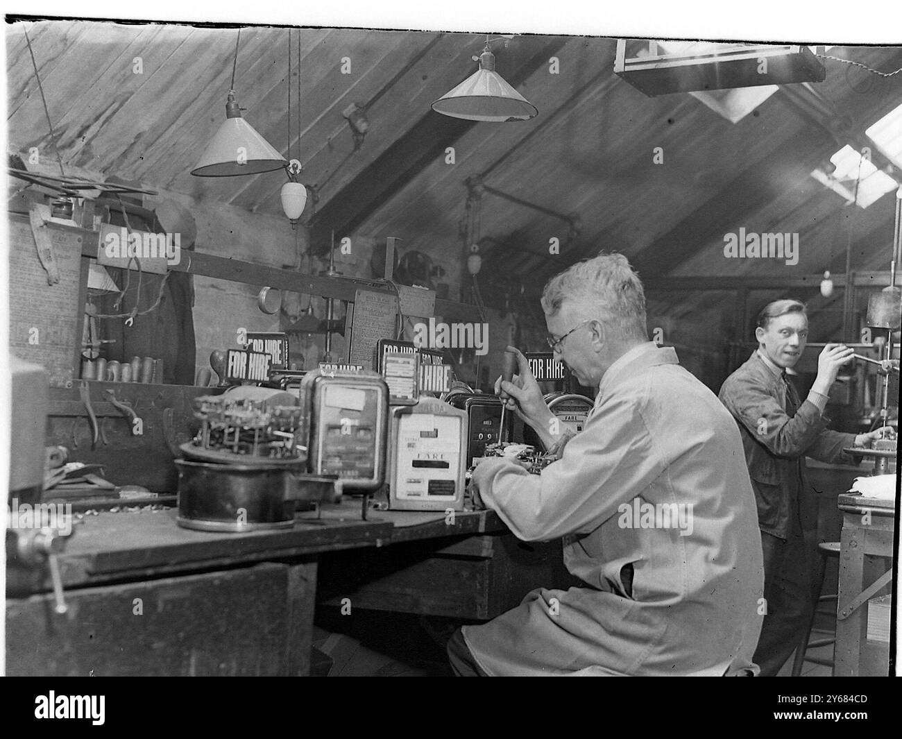Testing and making taxi meters at the works of British Taxi Meter Co ...
