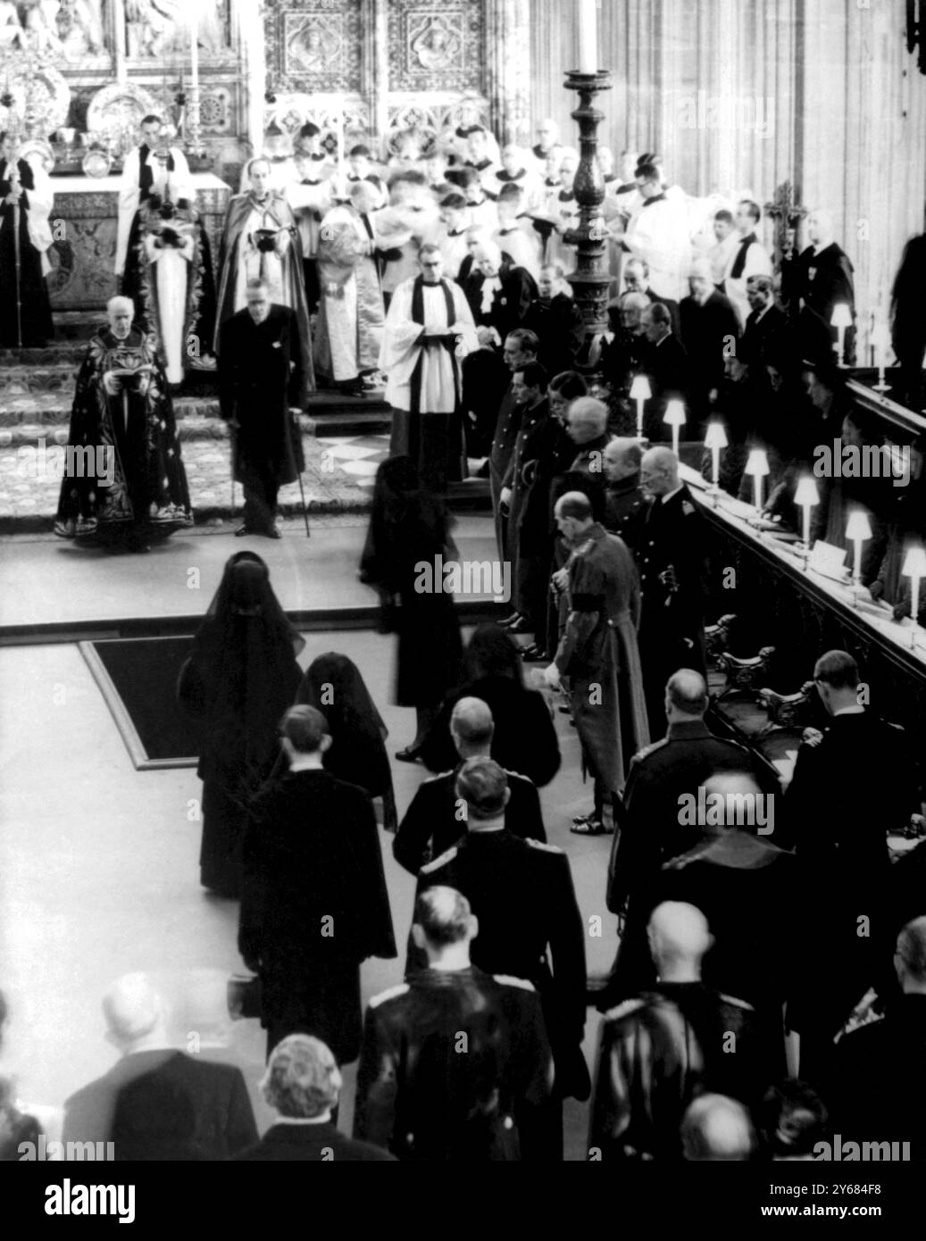 Queen Elizabeth II stands to the right of the Royal Tomb in St George's ...