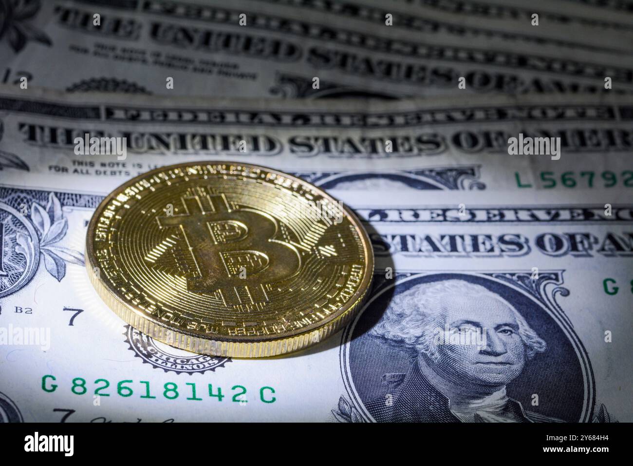 Concept picture of a physical bitcoin coin with dollar notes Stock ...