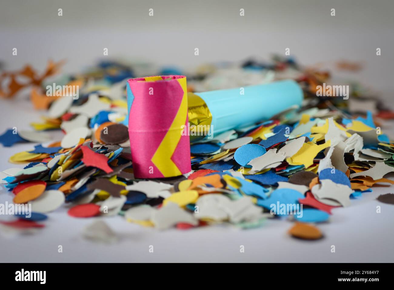 Party horns on colorful confetti stillife Stock Photo - Alamy