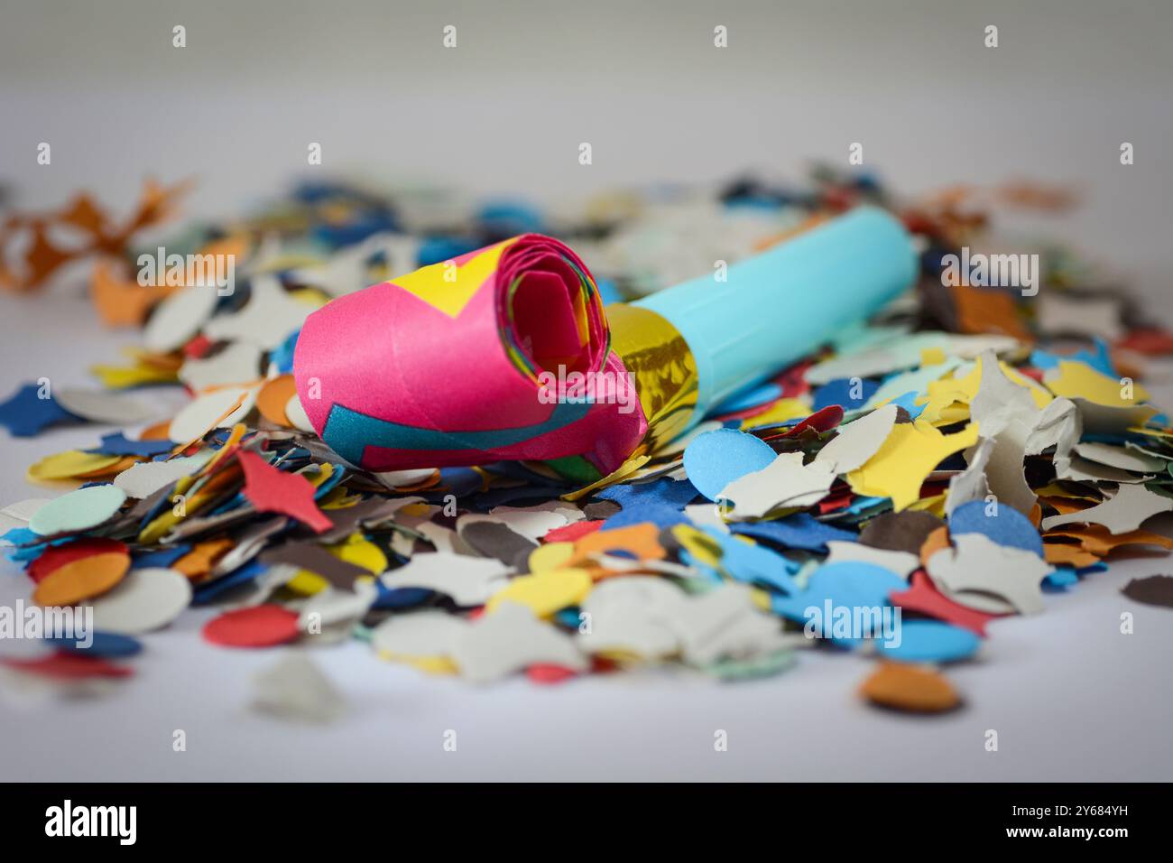 Party horns on colorful confetti stillife Stock Photo - Alamy