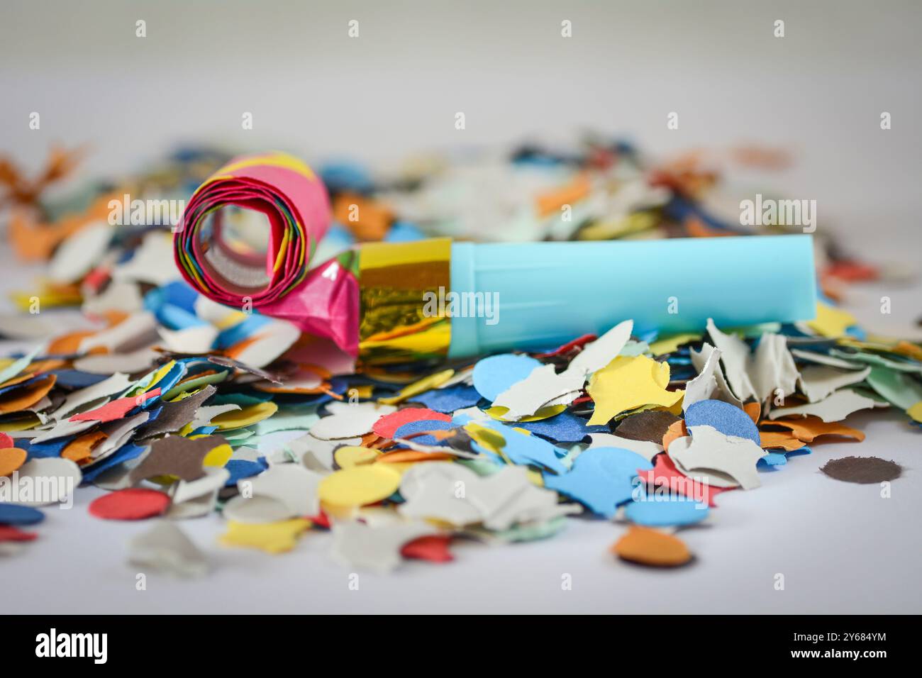 Party horns on colorful confetti stillife Stock Photo - Alamy