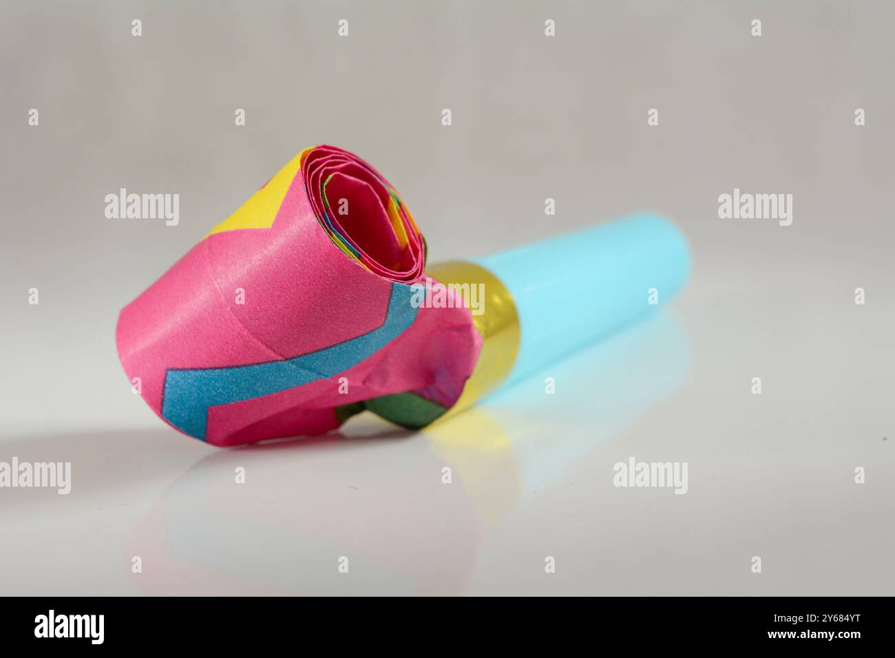 Party horns on colorful confetti stillife Stock Photo - Alamy
