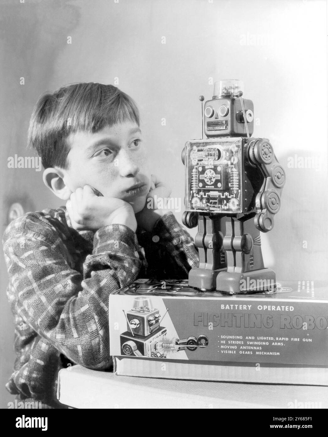 A fighting robot, he strides with his arms swinging, and a flashing gun ...