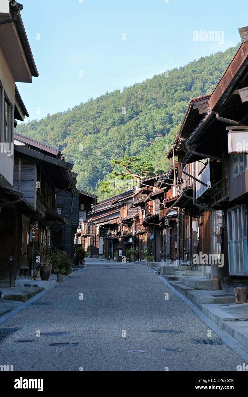 A tranquil street lined with traditional wooden houses in a Japanese ...