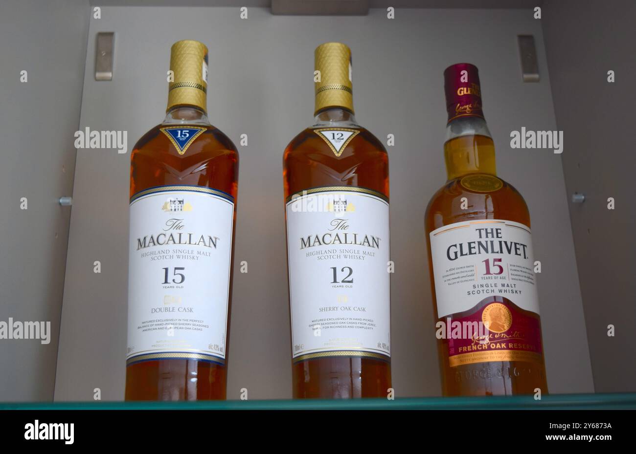 Display cabinet shelves with whiskey bottles collection Stock Photo - Alamy