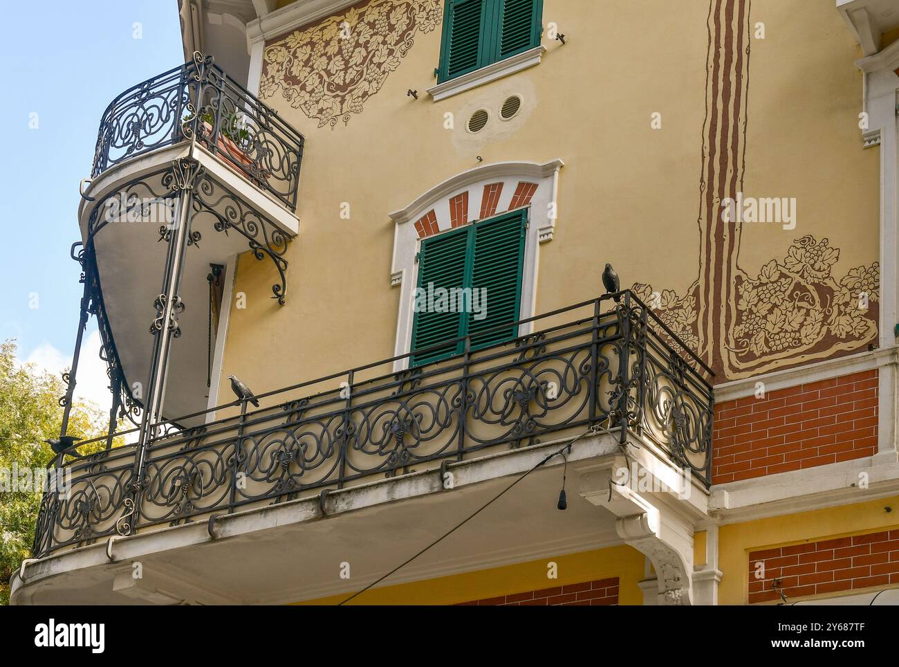 Exterior of an Art Nouveau palace with wrought iron balcony decorated ...