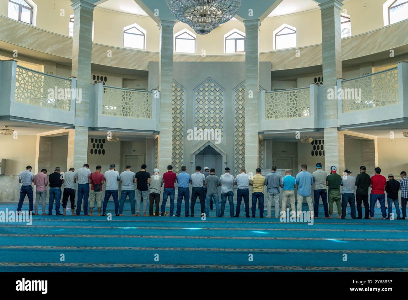 The group of Muslim men praying in Grand mosque of Maykop, Adygea ...