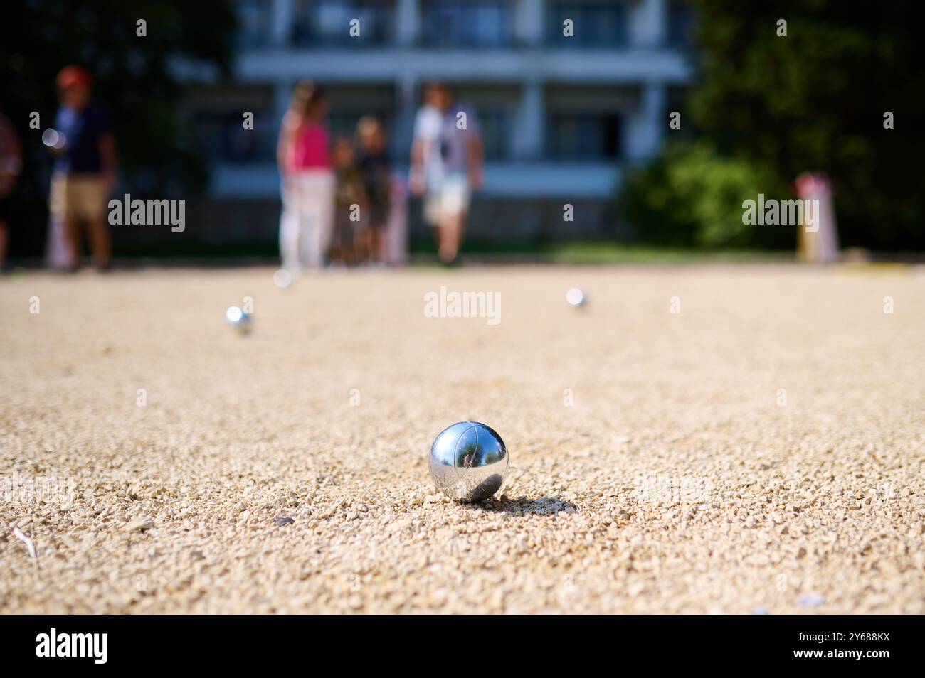 Close-up of petanque balls scattered on gravel with the target ball in ...