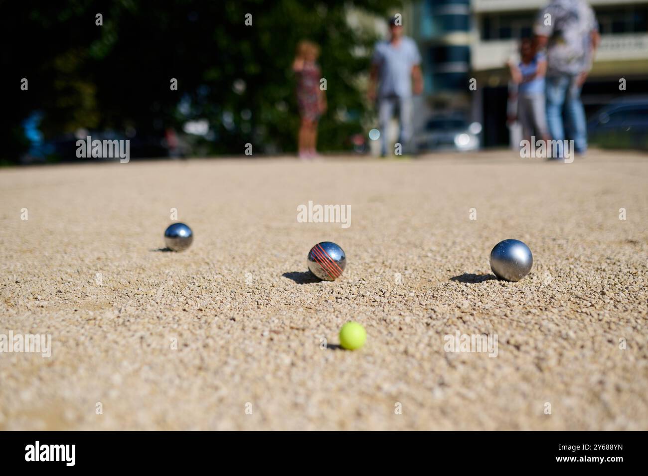 Close-up of petanque balls scattered on gravel with the target ball in ...