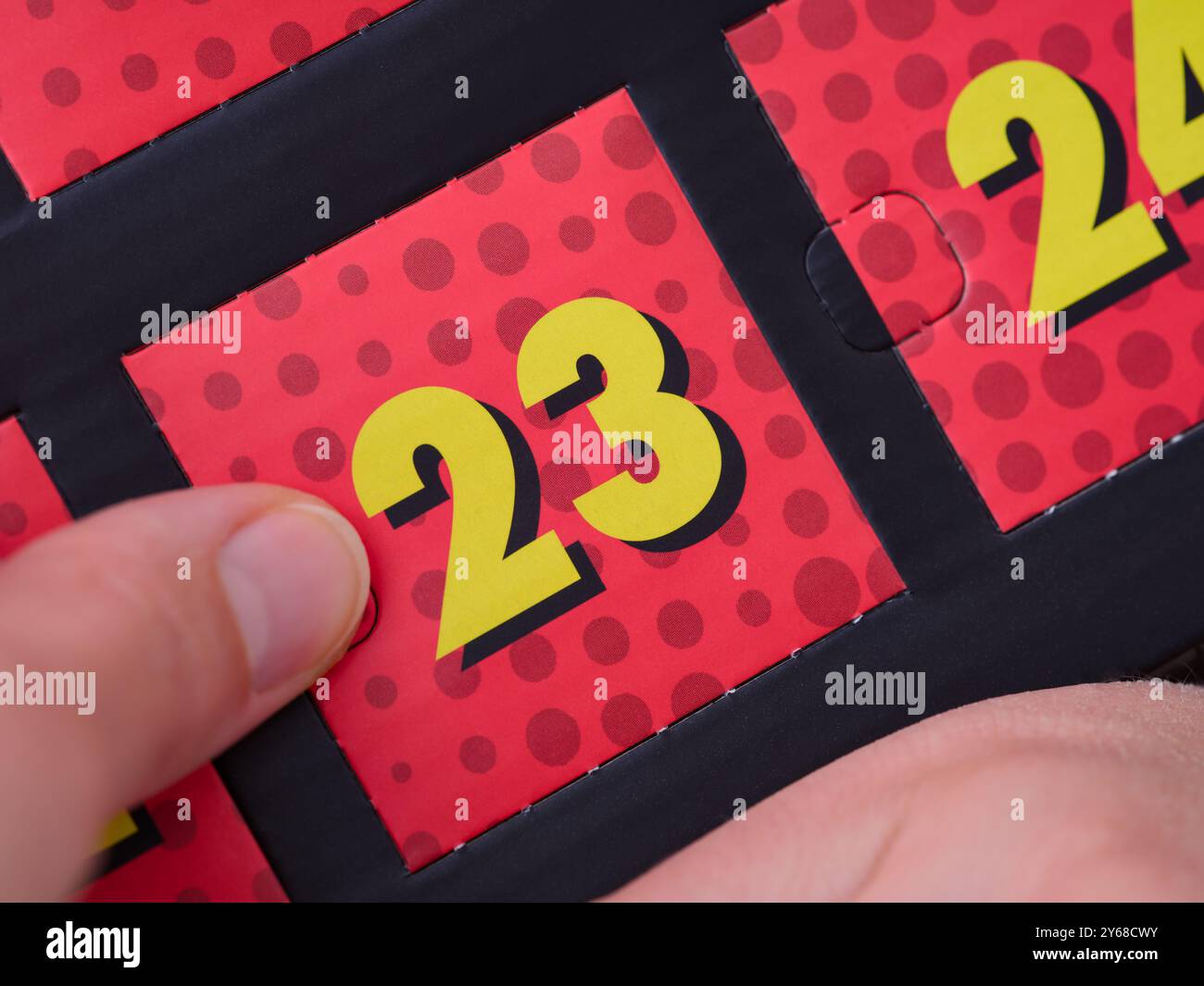 Woman hand ready to open the door with number 23 on the advent calendar ...