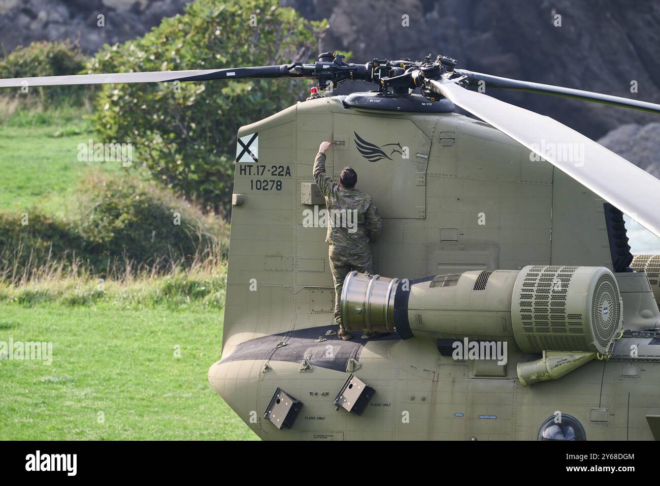 Soldier checking the rear rotor of a twin-rotor military transport ...