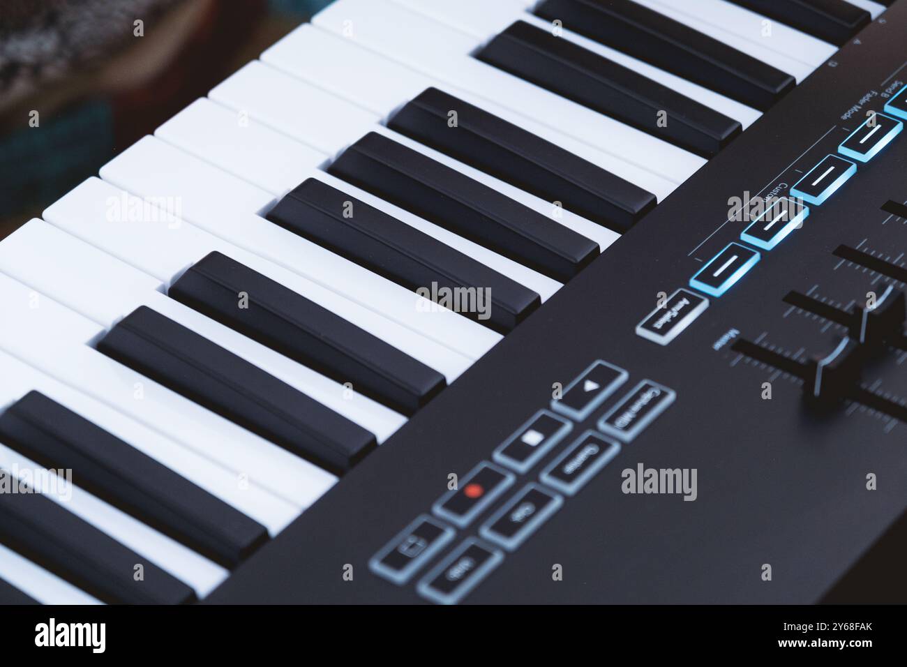 A detailed close-up of black and white keys on a modern synthesizer ...