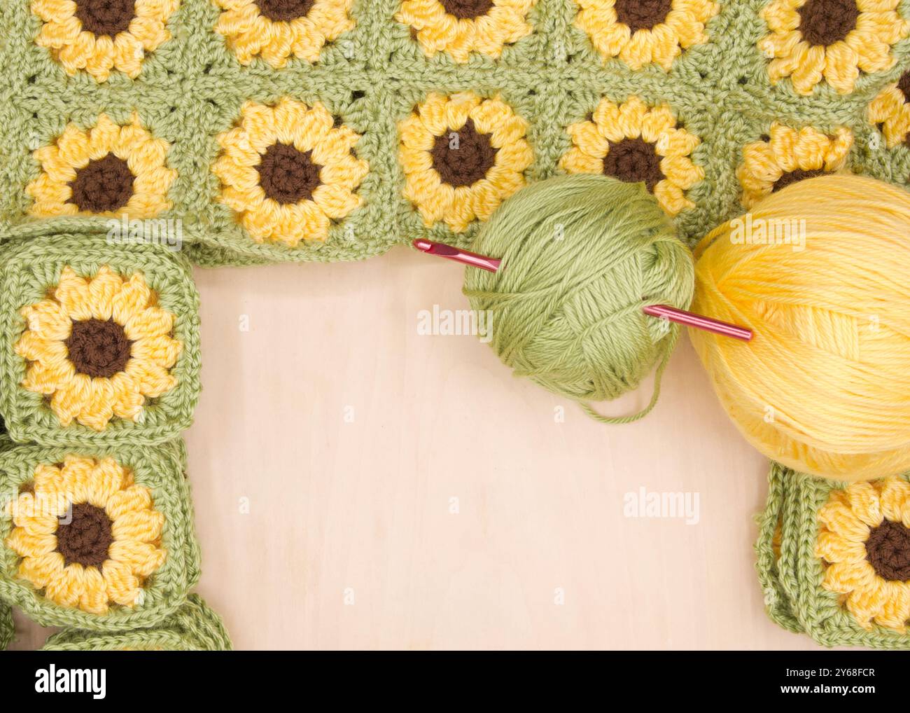 Close up on piles of finished crochet granny squares, connected squares ...