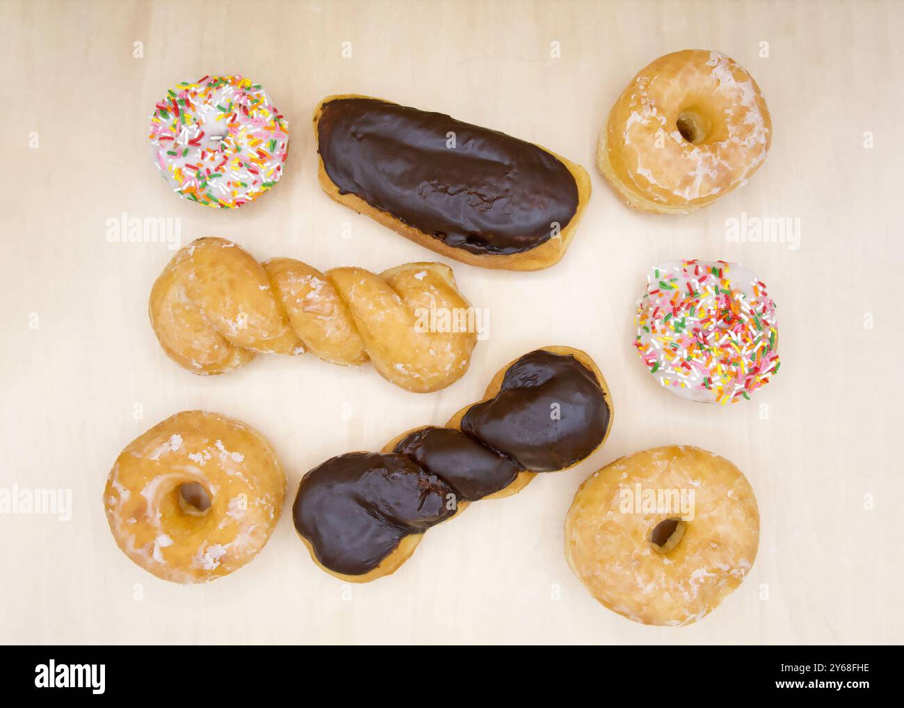 Flat lay top view of variety of donuts. Chocolate and Glazed twists ...
