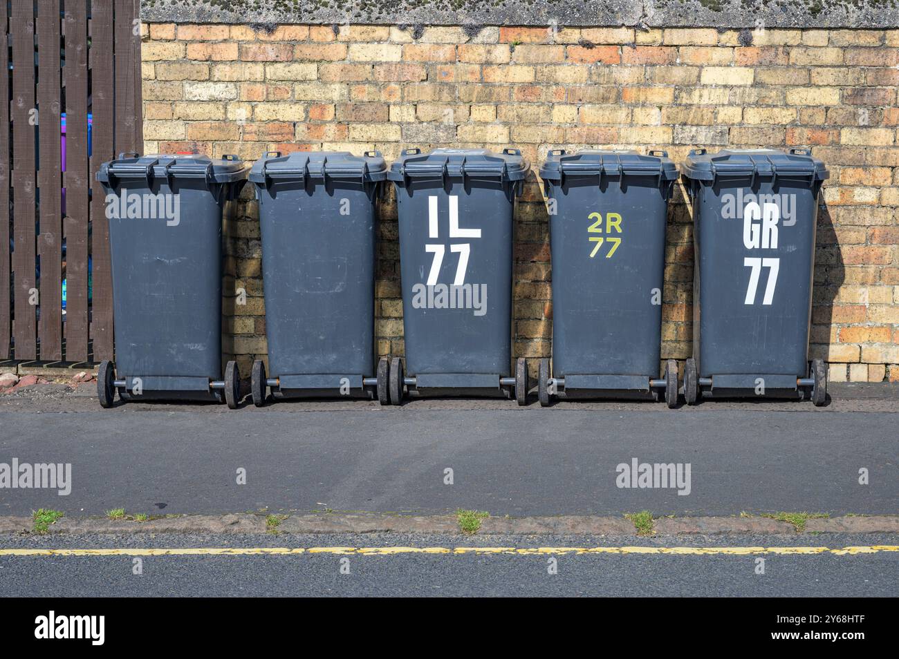 Residential rubbish bins on a pavement waiting to be emptied, Scotland ...