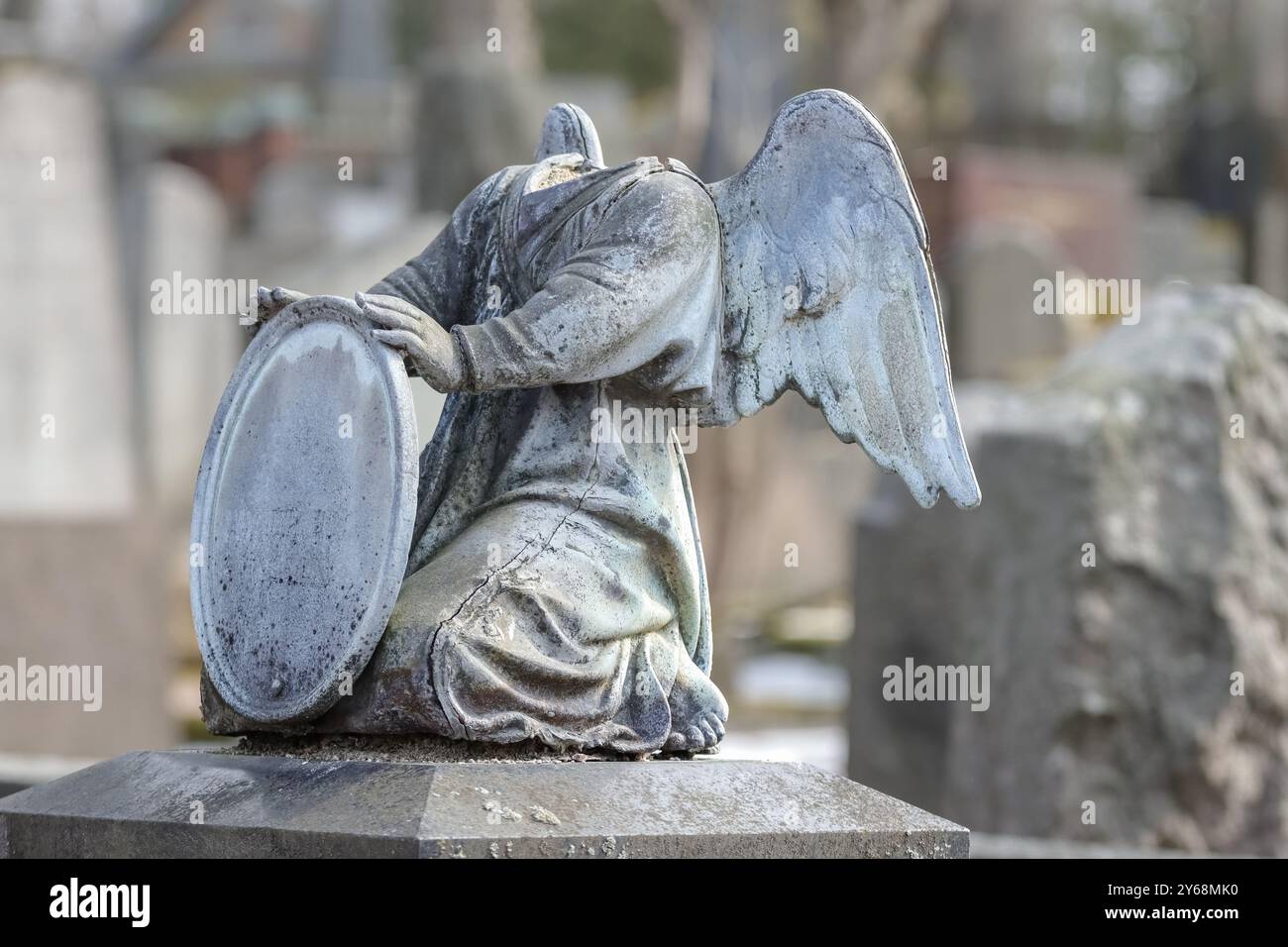 A large broken headless angel statue at the Hietaniemi cemetery in ...