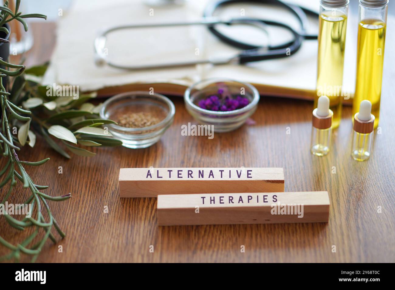 alternative therapies. table with stethoscope, oils and natural ...
