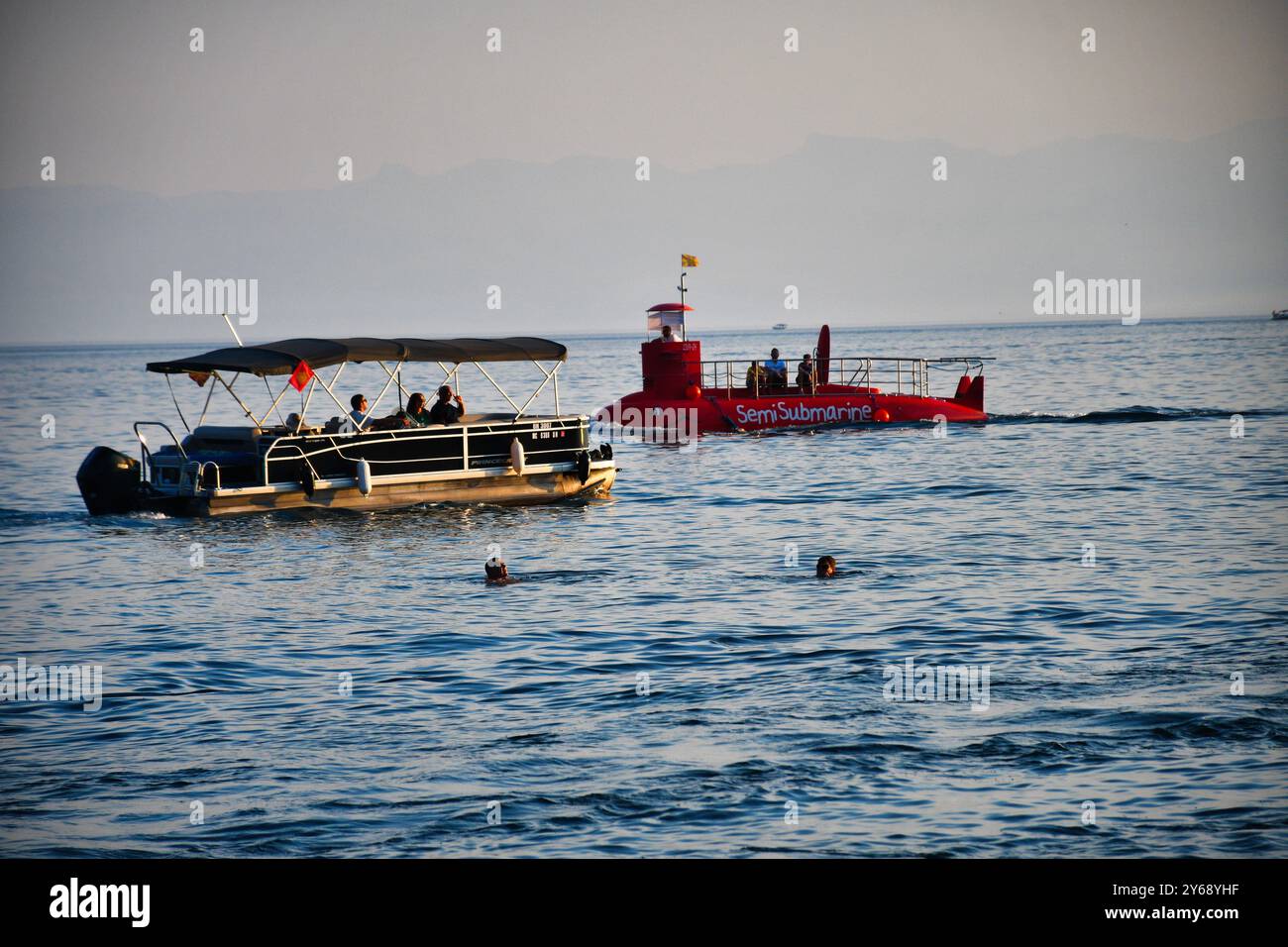 Boats of different sizes transport tourists through the waters of Lake ...