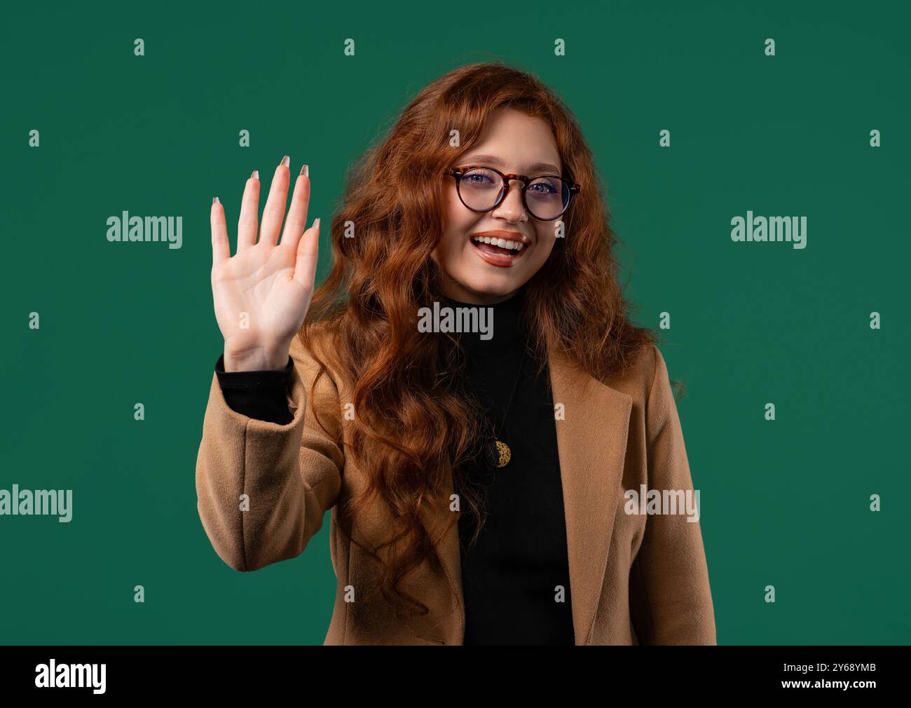 Friendly smiling girl waving hand hi-res stock photography and images ...