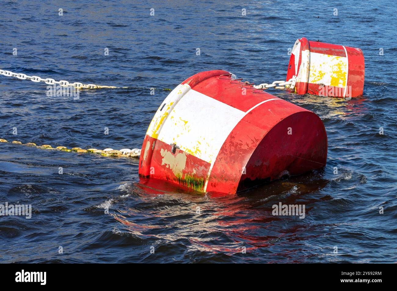 Buoy or float attached to the bottom by an anchor on a rope to indicate ...
