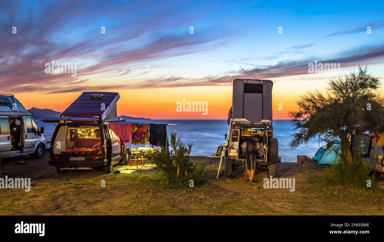 Campers and Motorhomes overlooking sunset in the Mediterranean sea from ...