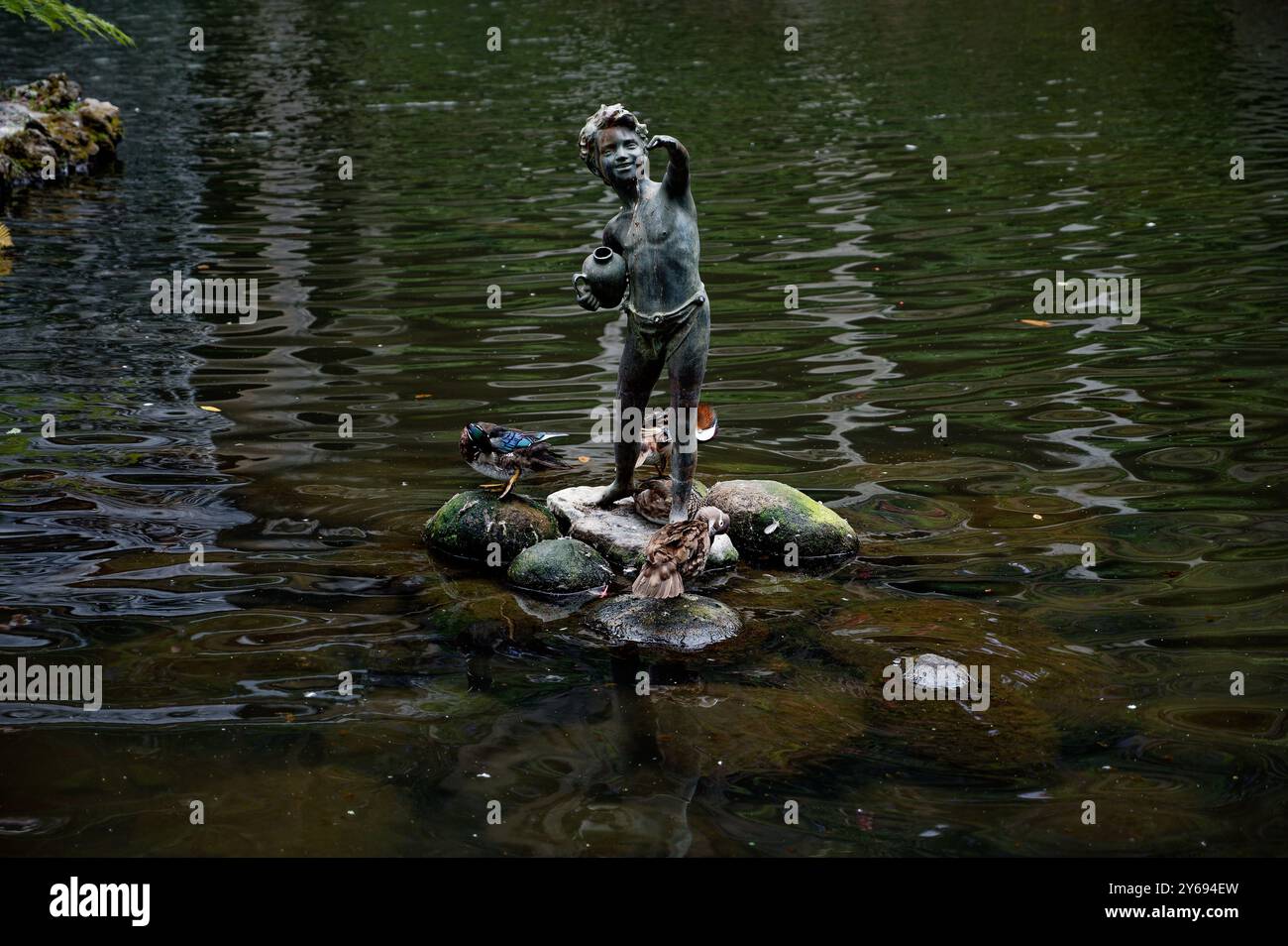 Playful child statue with ducks on a pond, monte palace gardens Stock ...
