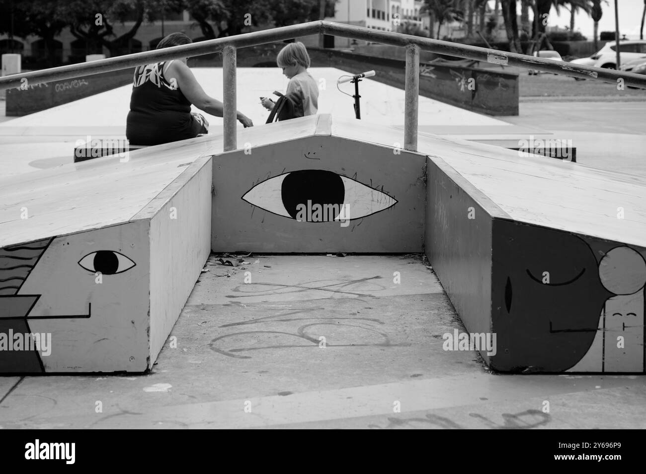 Monochrome, ramps with bold face designs at a funchal skatepark, a boy ...