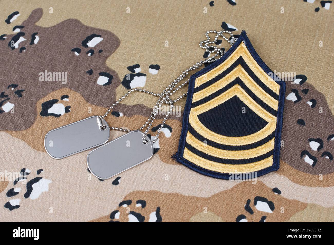 US ARMY Master Sergeant rank patch and dog tags on desert camouflage ...