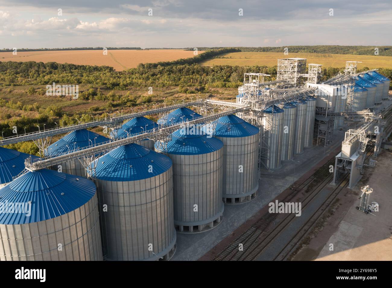 Aerial view of large silos with blue roofs, situated in a rural ...