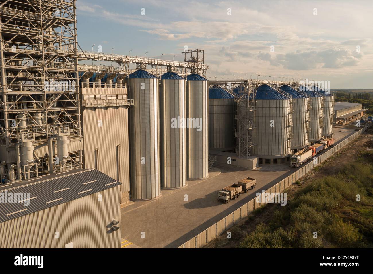 Aerial view of large silos with blue roofs, situated in a rural ...