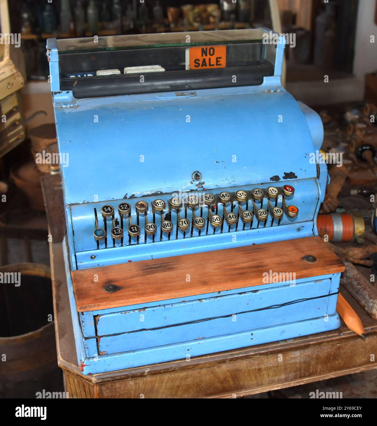Antique cash register, showing no sale, is bright blue, chipped and ...